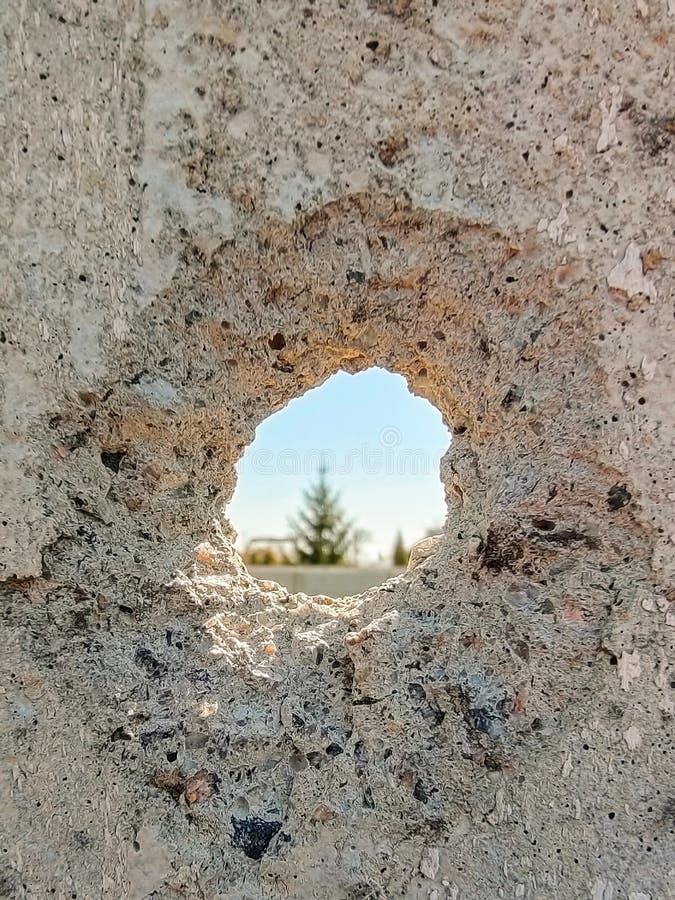 Bullet Hole in a Concrete Wall Close-up As a Result of the Fighting ...