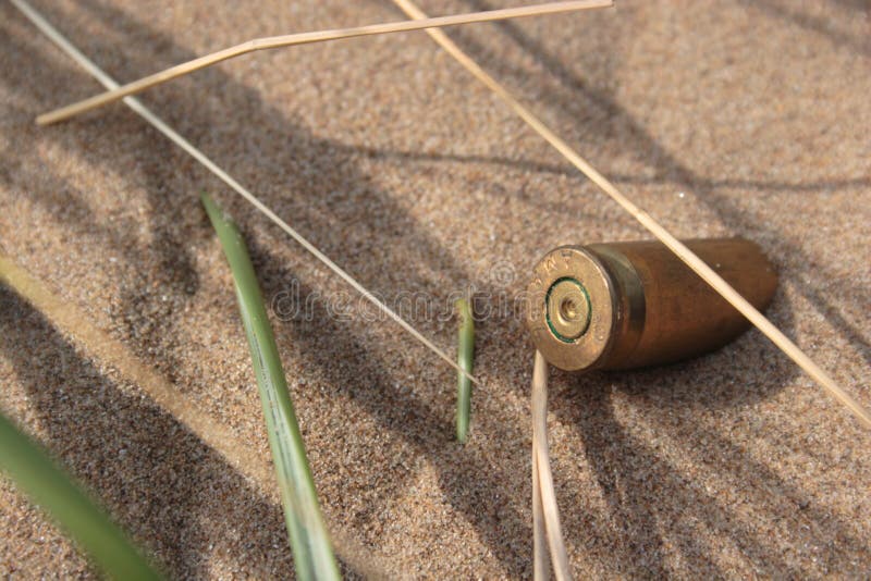 Bullet in the Sand 2 stock image. Image of beach, ammo - 3150955