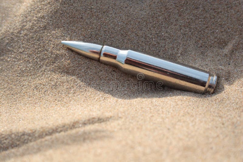 One Bullet Lying in Front of a Row of Bullets Stock Photo - Image of ...