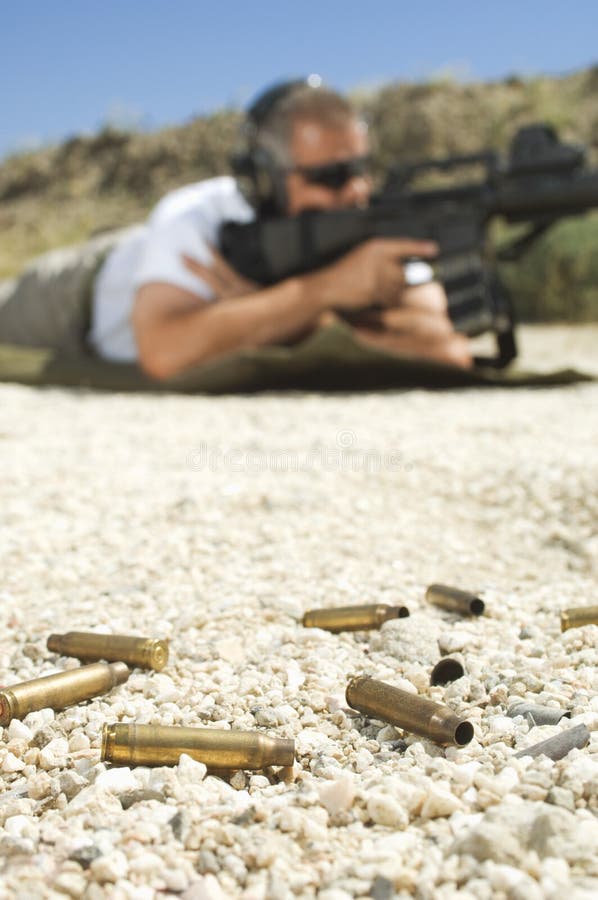 Bullets on Ground with Man Aiming Machine Gun Stock Image - Image of ...
