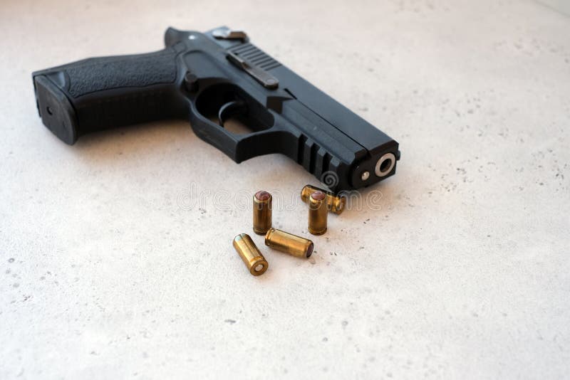 Bullets with Handgun in the Back of the Scene with Focus on the Bullet ...