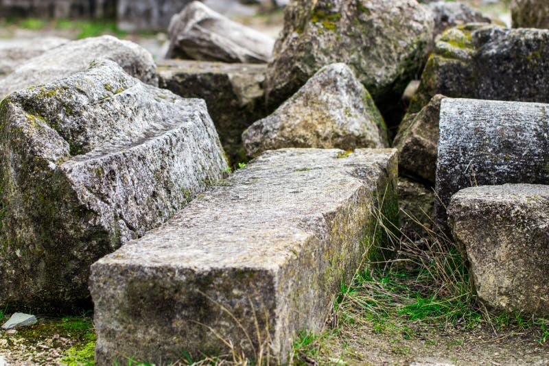 A Bunch of Ancient Stone Blocks Lying on the Grass Stock Photo - Image ...