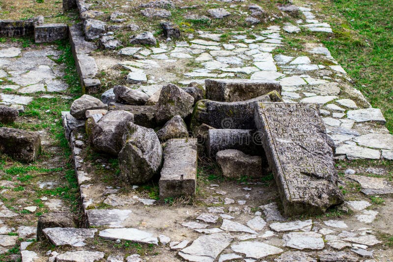 A Bunch of Ancient Stone Blocks Lying on the Grass Stock Photo - Image ...