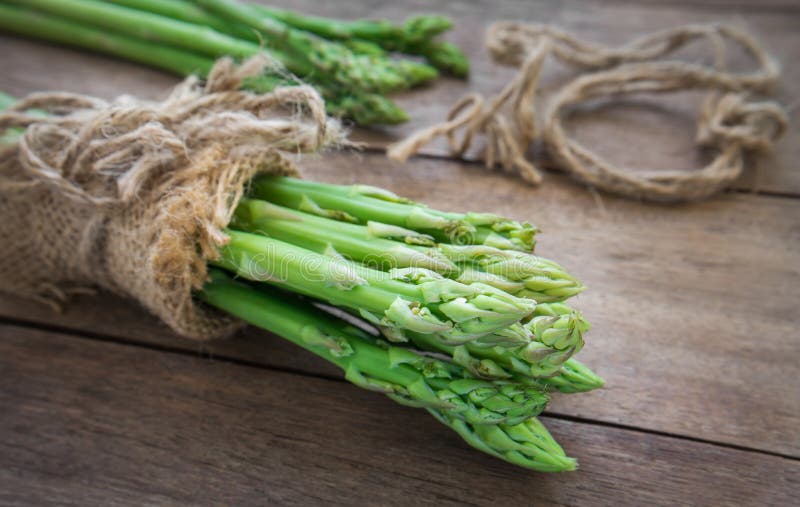 Bunch of Asparagus on Wooden Table Stock Photo - Image of uncooked ...