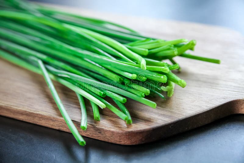 Bunch of Chives on a Wooden Cutting Board Stock Photo - Image of green ...