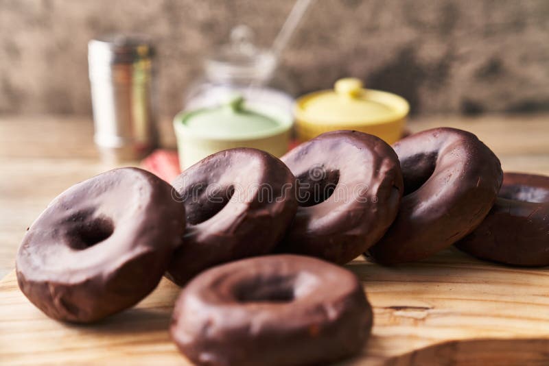 Bunch of Chocolate Doughnuts on a Wooden Surface Stock Image - Image of ...