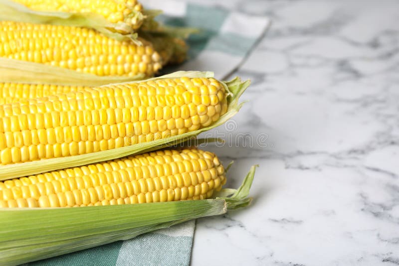 Bunch of Corn Cobs on White Marble Table, Closeup Stock Image - Image ...