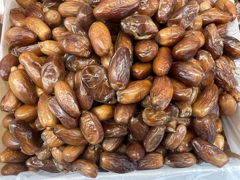 A Bunch of Dates in a Container. it is a Fruit with a Sweet Taste Stock ...