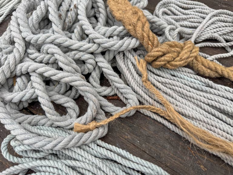 A Bunch of Different Colored Strings are Tangled Together on a Wooden ...