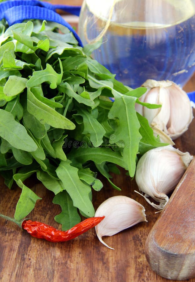 Bunch of Fresh Arugula with Garlic and Pepper Stock Photo - Image of ...