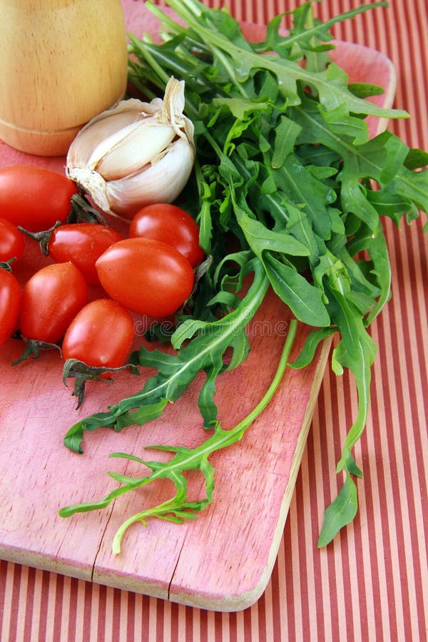 Bunch of Fresh Arugula with Garlic and Tomato Stock Photo - Image of ...