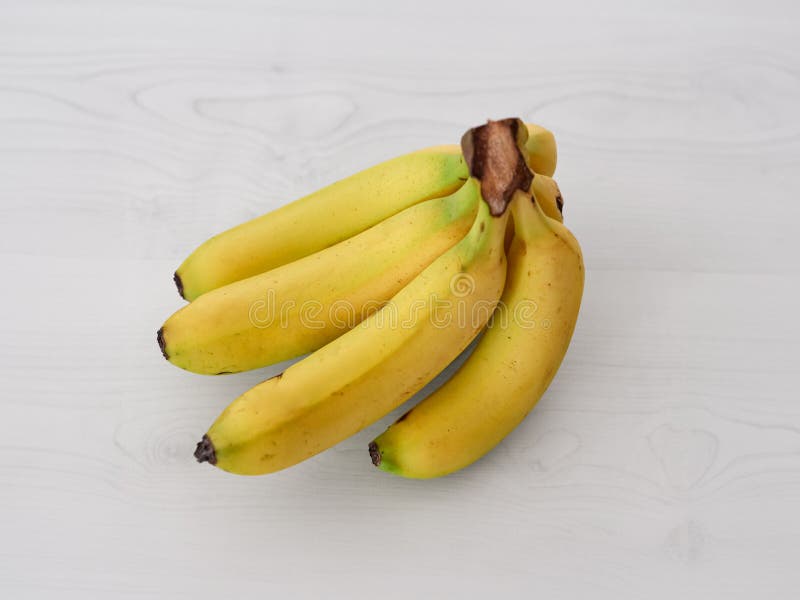 Bunch of Fresh Bananas on a White Wooden Kitchen Table. Top View Stock ...