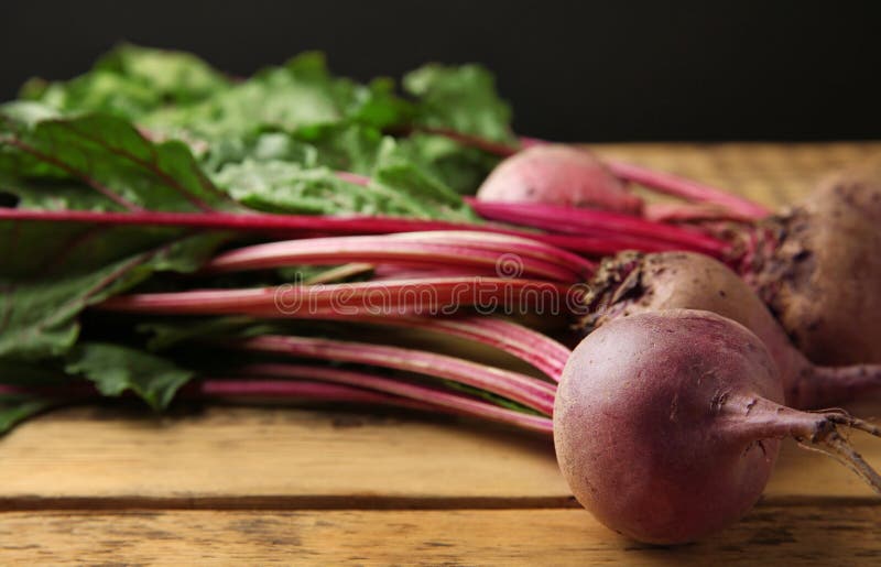 Bunch of Fresh Beets with Leaves on Wooden Table Against Black ...