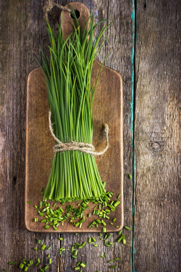 Bunch of Fresh Chives on a Wooden Cutting Board Stock Photo - Image of ...