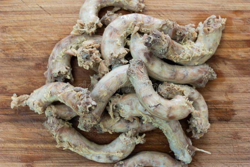 Bunch of Fresh Cooked Chicken Necks Set on a Wooden Board in a Kitchen ...