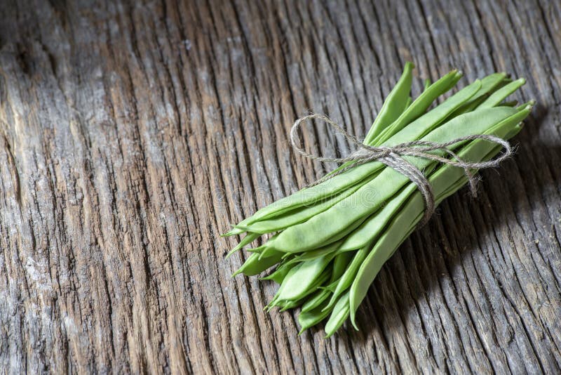Bunch of Green Flat Beans Tied with a String on an Old Wooden Plank ...