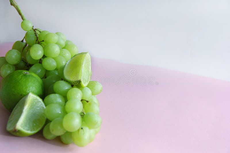 A Bunch of Green Grapes and Lime, Lime Slices Close-up on a Bright ...