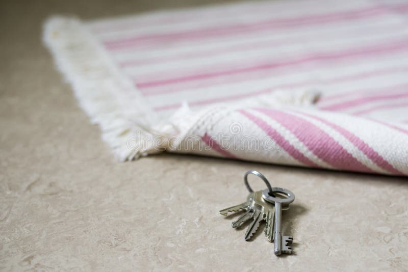 Bunch of Keys Left on the Doorstep Under the Carpet Stock Image - Image ...
