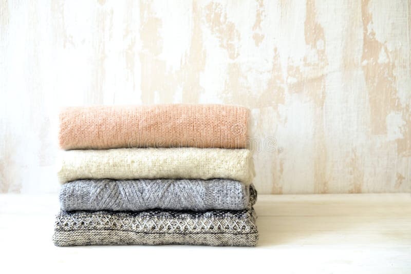 Minimalistic Rustic Composition with Stacked Vintage Knitted Sweaters ...