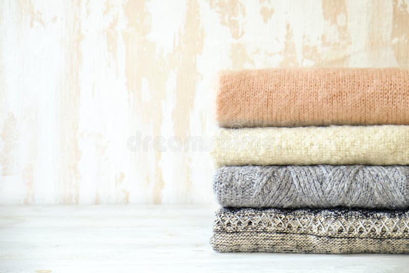 Minimalistic Rustic Composition with Stacked Vintage Knitted Sweaters ...