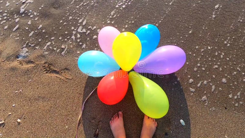 Bunch Multi-colored Balloons Lying Wet Sand Beach Seashore with Rolling ... Bunch Multi-colored Balloons Lying Wet Sand Beach Seashore with Rolling ...
