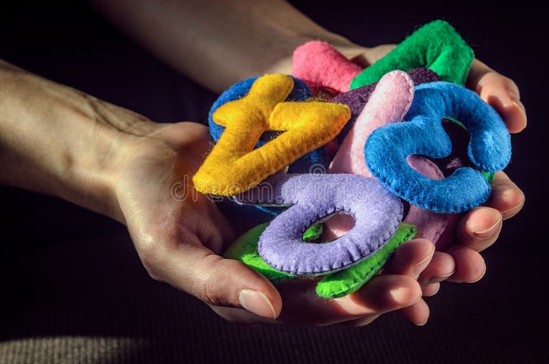 Bunch of Multi-colored Numbers of Felt in the Palms Stock Image - Image ...