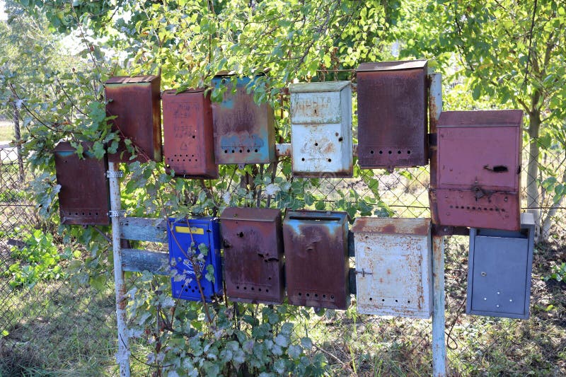 A Bunch of Old Rusty Mailboxes on a Fence Stock Photo - Image of mail ...