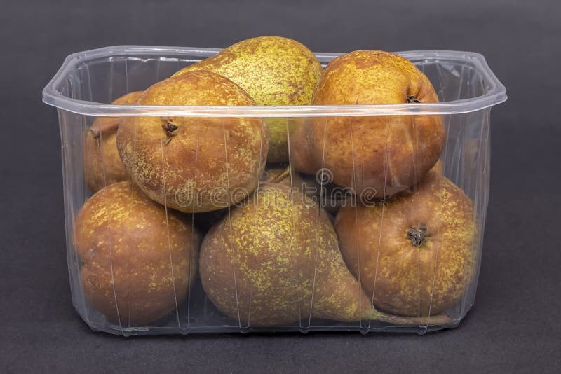 A Bunch of Pears are Lying in a Transparent Plastic Box on a Dark ...