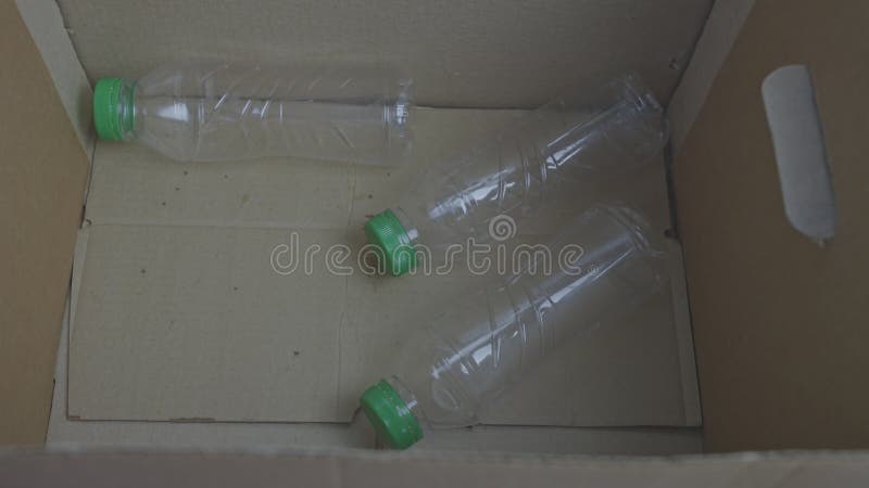 Bunch of Plastic Bottles Falling into Cardboard Box Stock Video - Video ...