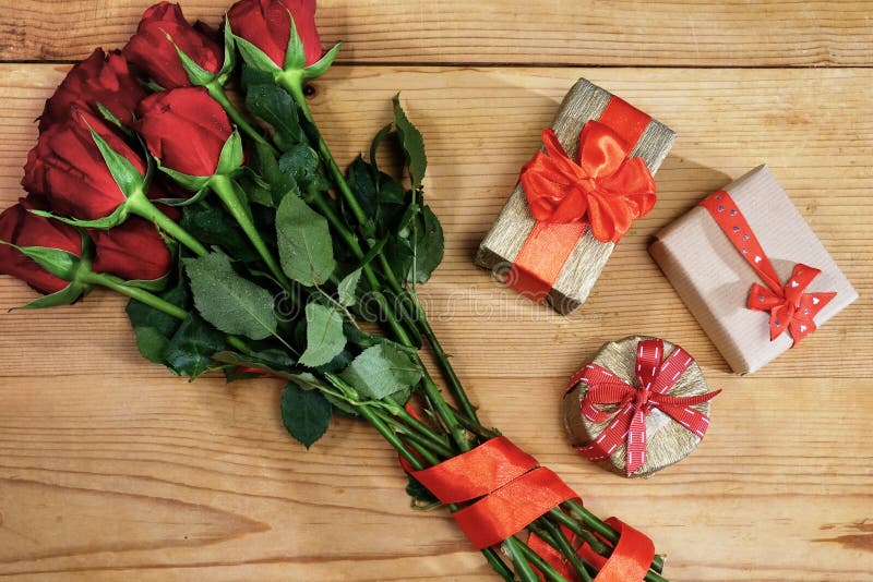 Bunch of Red Roses with Ribbon and Three Gift Boxes Stock Photo - Image ...