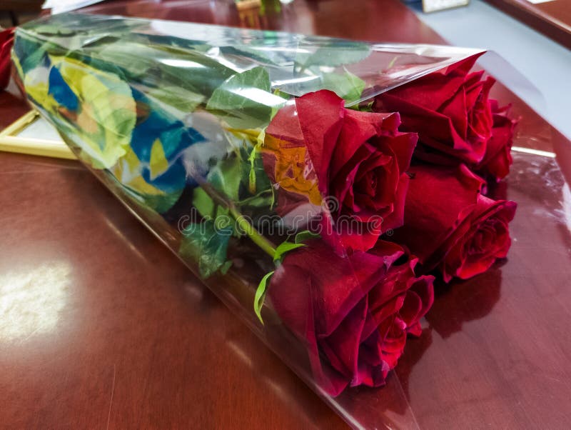 A Bunch of Red Roses Sitting on Top of a Table Stock Image - Image of ...