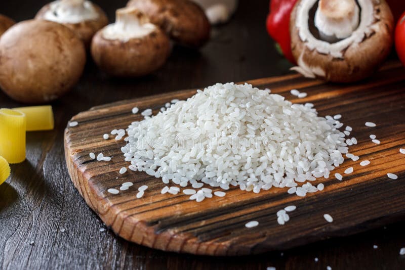 Bunch of Rice on a Wooden Kitchen Board. Stock Photo - Image of kitchen ...
