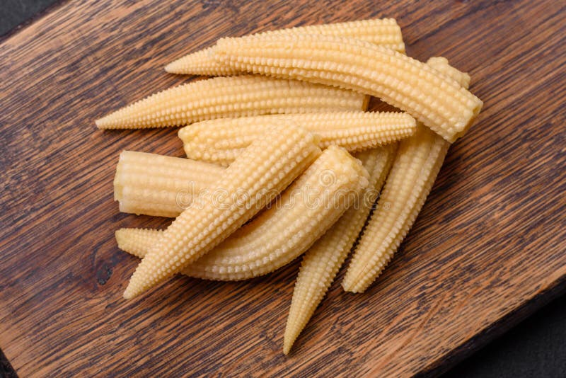 A Bunch of Small White Canned Corn on a Dark Concrete Background Stock ...