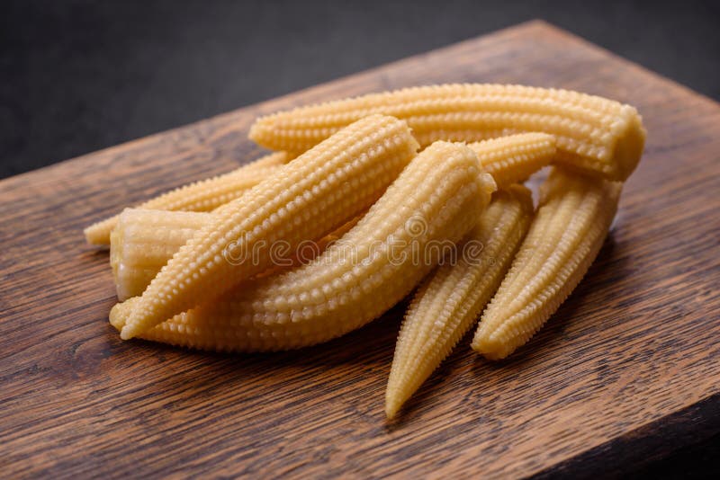 A Bunch of Small White Canned Corn on a Dark Concrete Background Stock ...