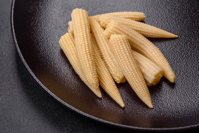 A Bunch of Small White Canned Corn on a Dark Concrete Background Stock ...