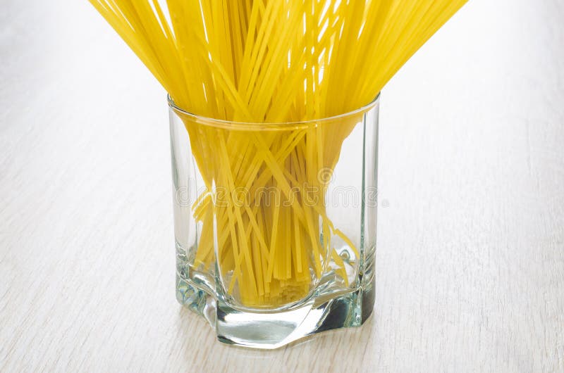 Bunch of Spaghetti in Glass on Table Stock Photo - Image of table ...