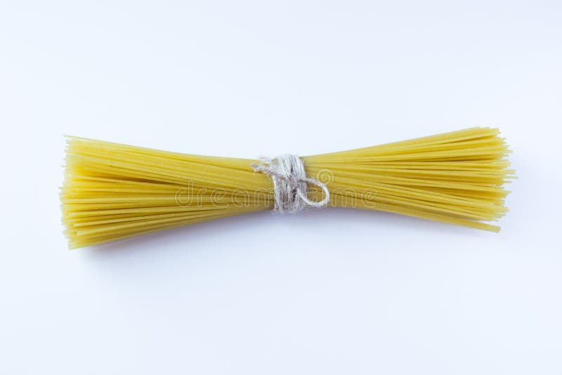 Bunch of Tied Spaghetti Sticks at White Plate with Colorful Fusilli and ...