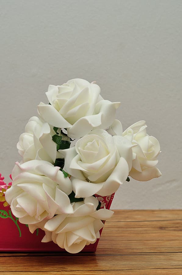 A Bunch of White Artificial Roses in a Pink Container Stock Photo ...