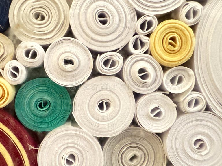 A Bunch of White and Colored Paper Rolls are Piled on Top of Each Other ...