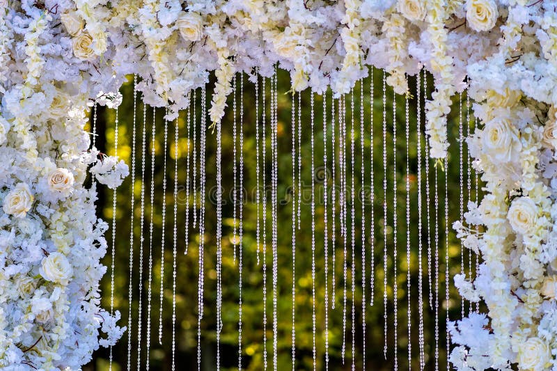 Bunch of White Flowers Hanging from the Side of Building with Chains ...
