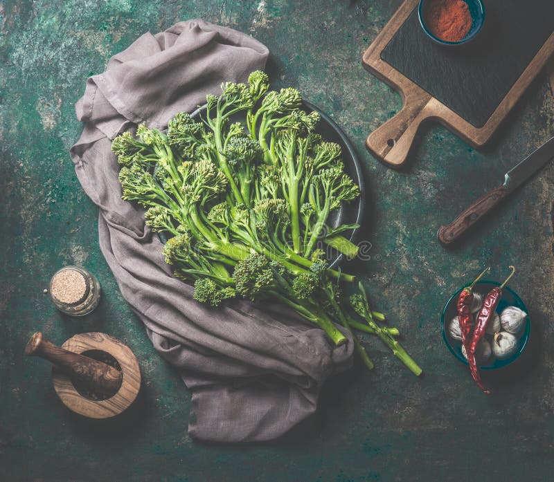 A Bunch of Young Wild Broccoli on a Rustic Table with Various Kitchen ...