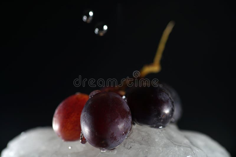 Bunches of Grapes in Ice Water with Colorful Flashes Photographed in ...