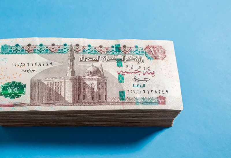 Stack of Egyptian 100 Pound Notes on a Blue Background Stock Photo ...