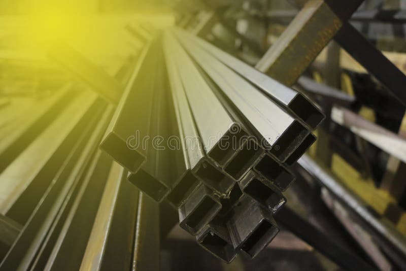 A Bundle of Long Steel Square Tubes of Black Metal with a Small Rust ...