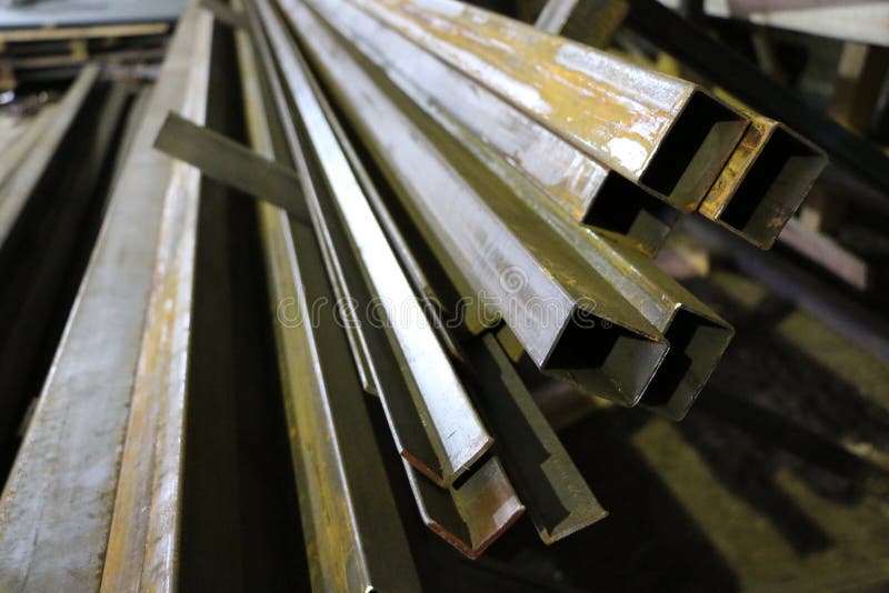 A Bundle of Long Steel Square Tubes of Black Metal with a Small Rust ...