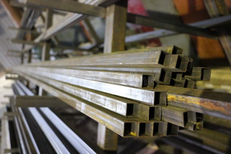 A Bundle of Long Steel Square Tubes of Black Metal with a Small Rust ...