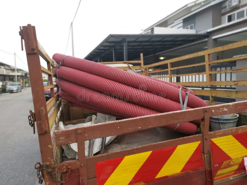 Bundle of Vermilion Red PVC Plastic Industrial Pipe Hose at the Back of ...