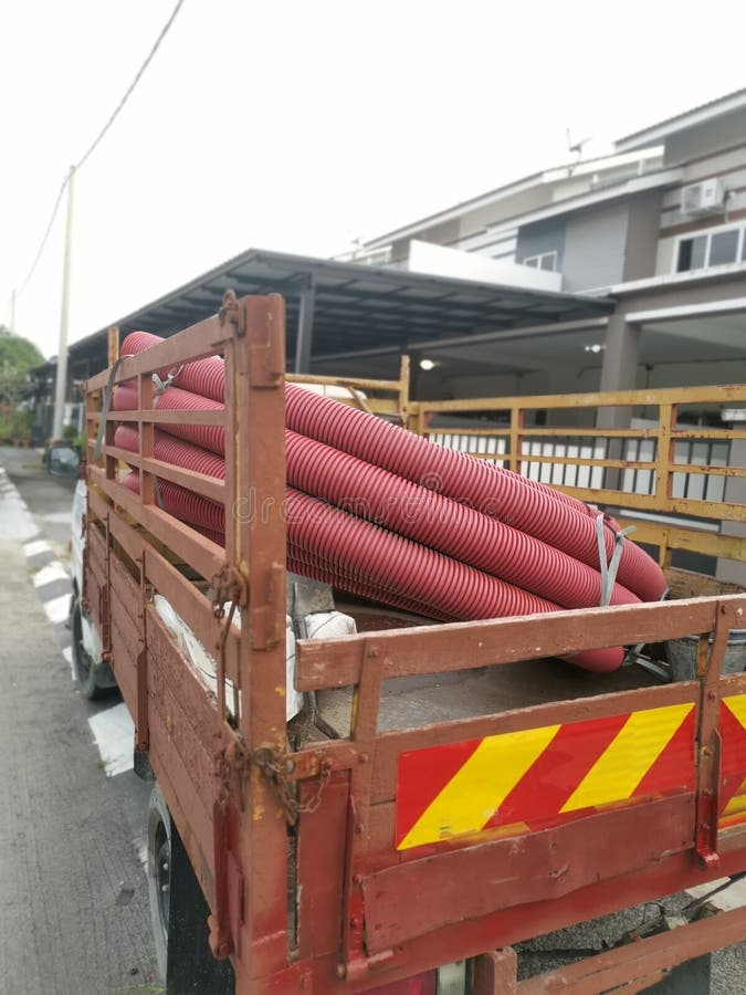 Bundle of Vermilion Red PVC Plastic Industrial Pipe Hose at the Back of ...