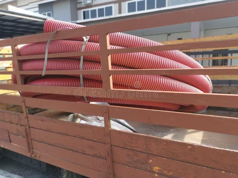 Bundle of Vermilion Red PVC Plastic Industrial Pipe Hose at the Back of ...