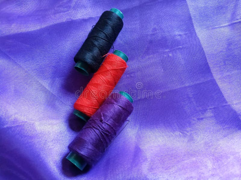Bundles of Colorful Threads on Purple Fabric, Suitable for Weaving or ...